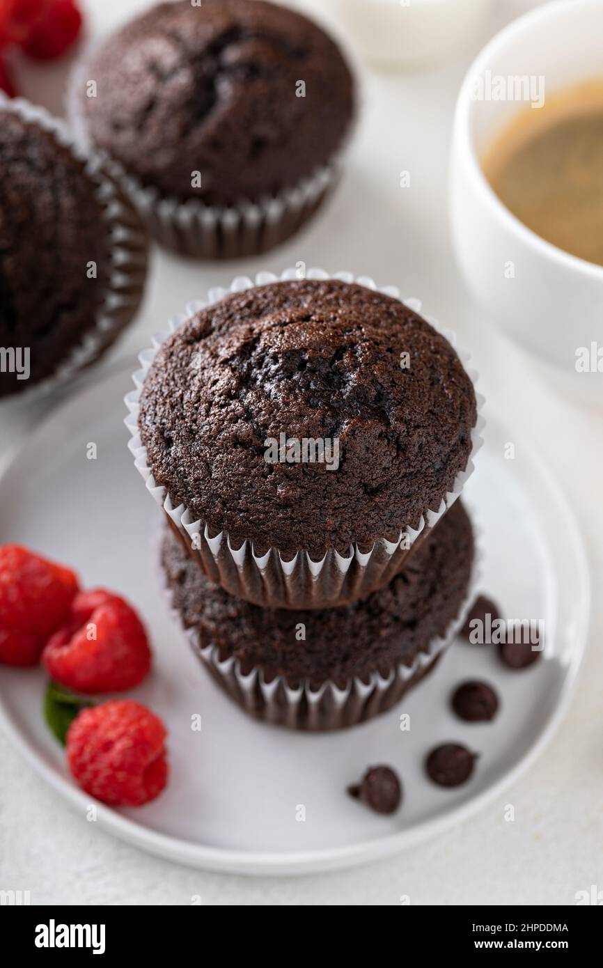 Chocolate muffins served with coffee with raspberries Stock Photo - Alamy