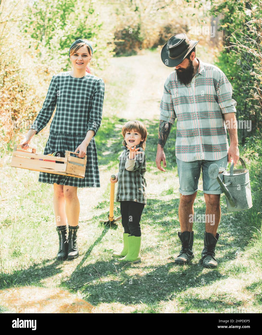 Young family with child having fun in nature. Life for family farmers ...