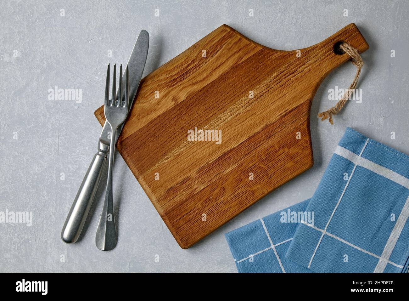 Brown wooden cutting board with cutlery and dinner napkins Stock Photo ...