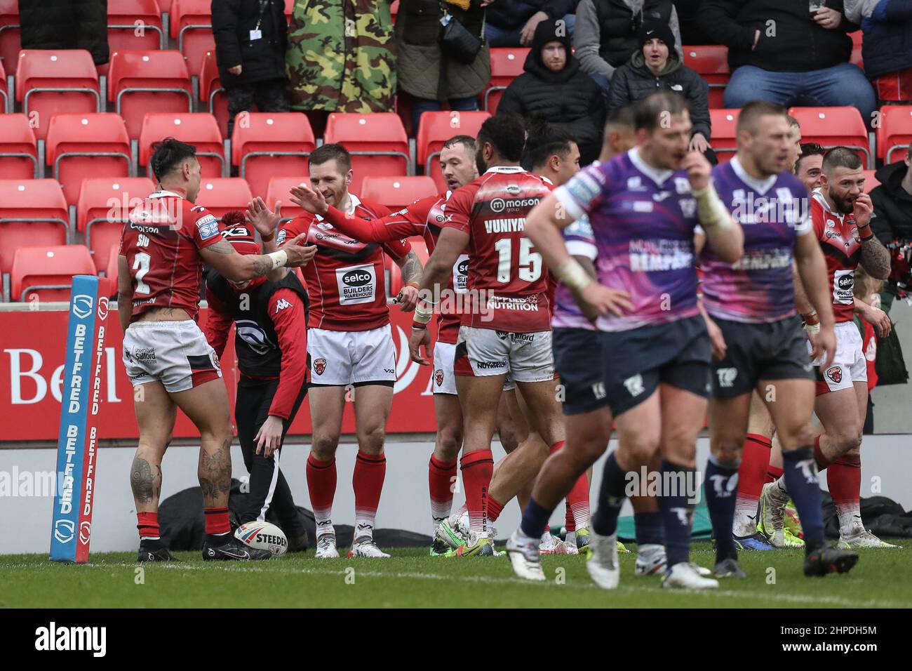Ken Sio #2 of Salford Red Devils celebrates his try with his team mates ...