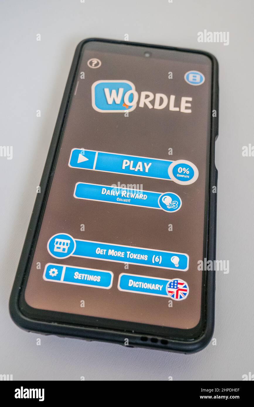 Wordle game on a smart phone with blue letters and dark background ...