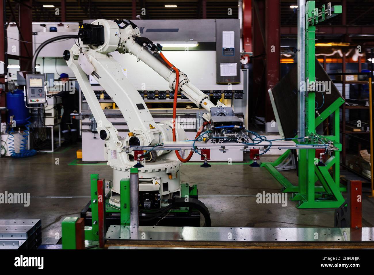 Robotic arm working with metal sheet at metalworking factory Stock ...