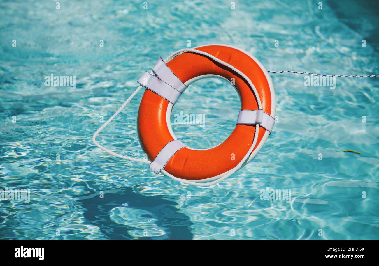 Lifebuoy pool ring float on blue water Stock Photo - Alamy