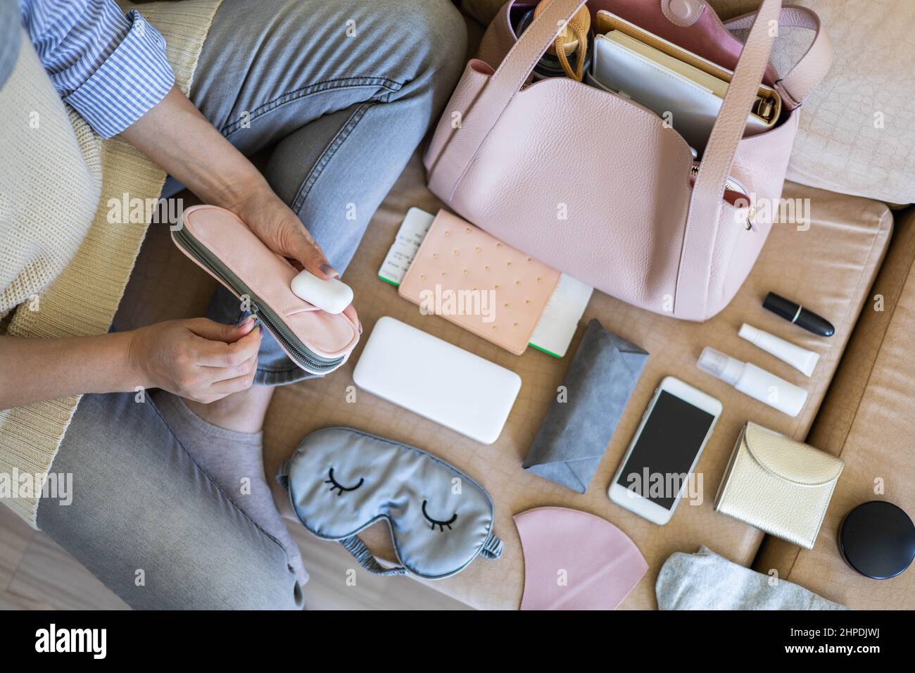 Top view woman getting ready to flight putting different personal ...
