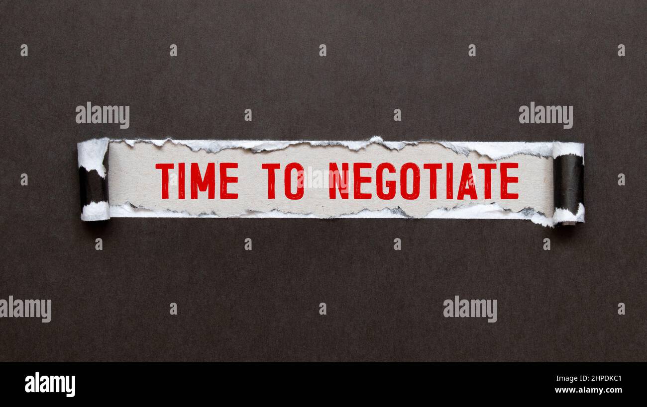 TIME TO NEGOTIATE text on notebook with office supplies on the white ...