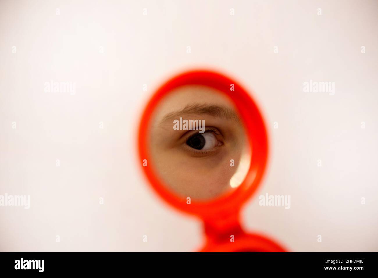 Hand holding a mirror with the reflection of the girl's eye Stock Photo ...
