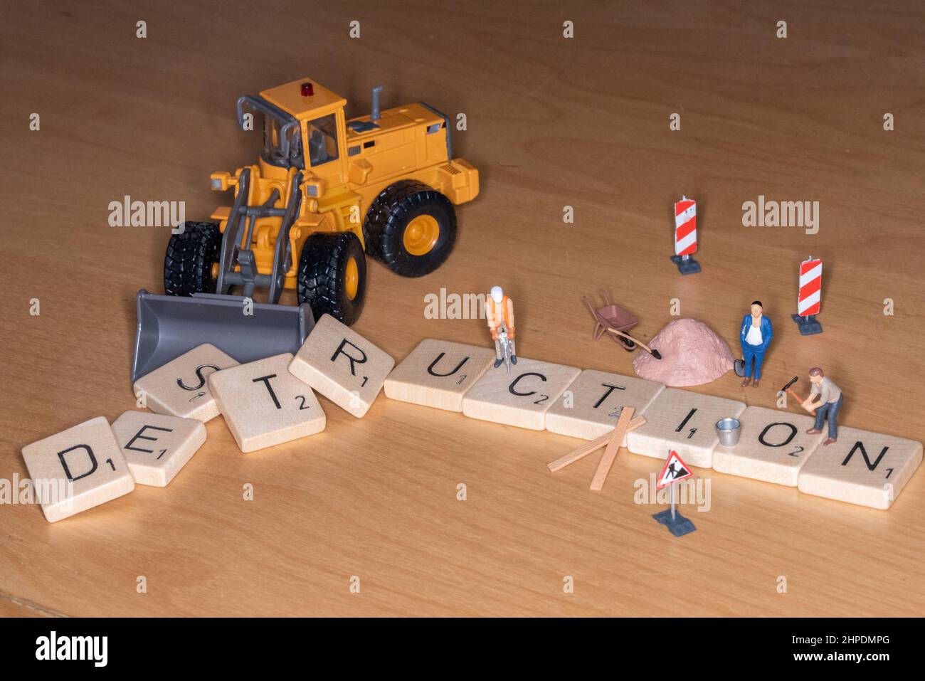 Miniature figures demolishing the word "destruction Stock Photo - Alamy