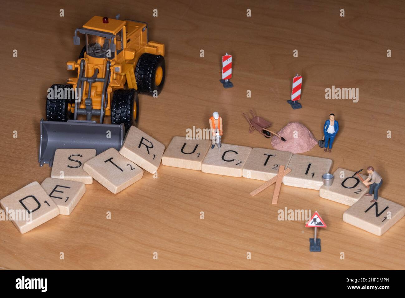 Miniature figures demolishing the word "destruction Stock Photo - Alamy