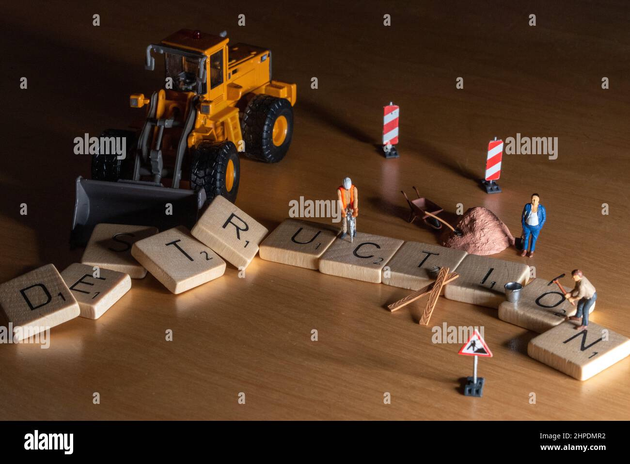 Miniature figures demolishing the word "destruction Stock Photo - Alamy