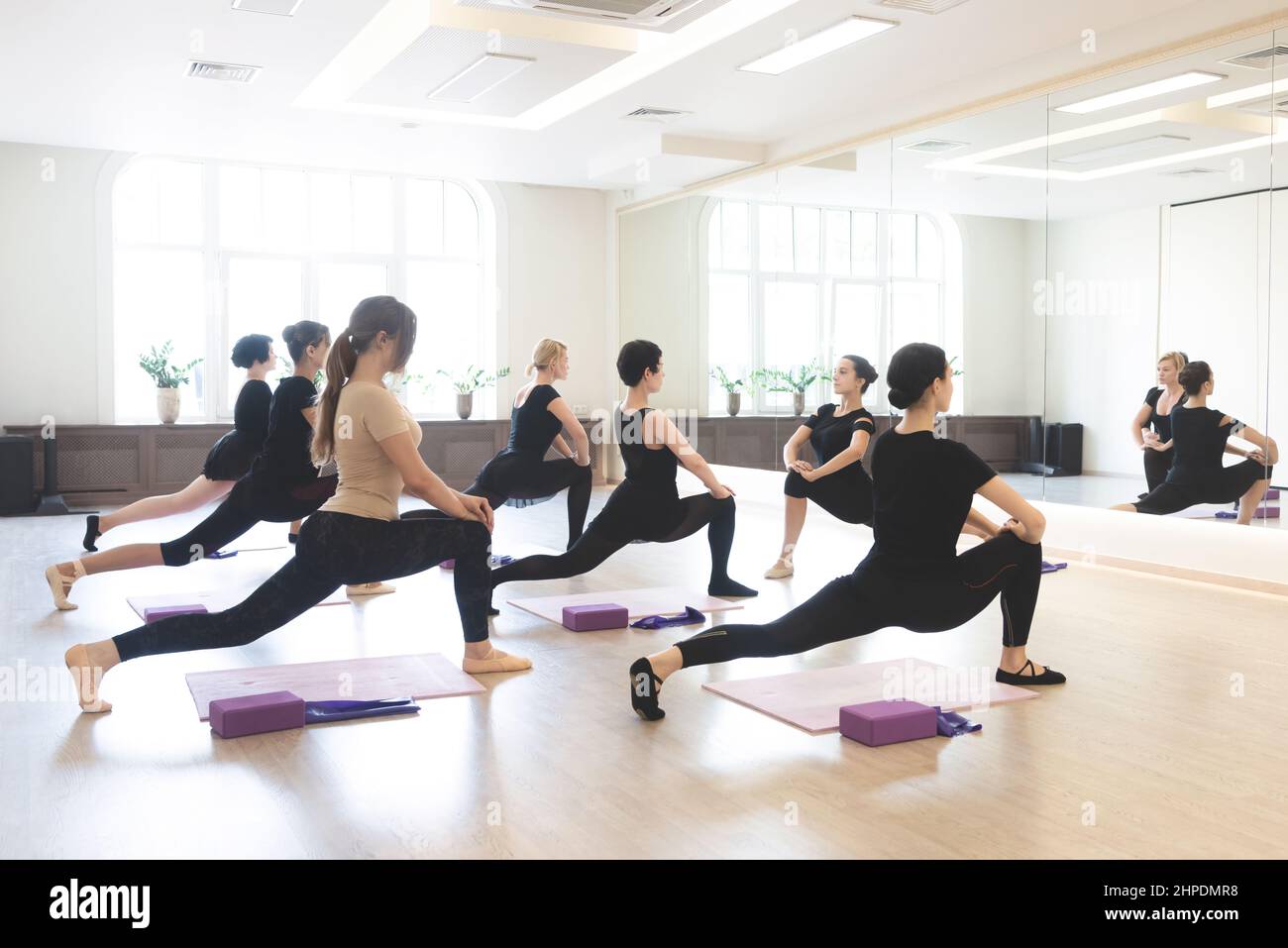 Five dancer girls warming up with stretching exercises for flexibility ...