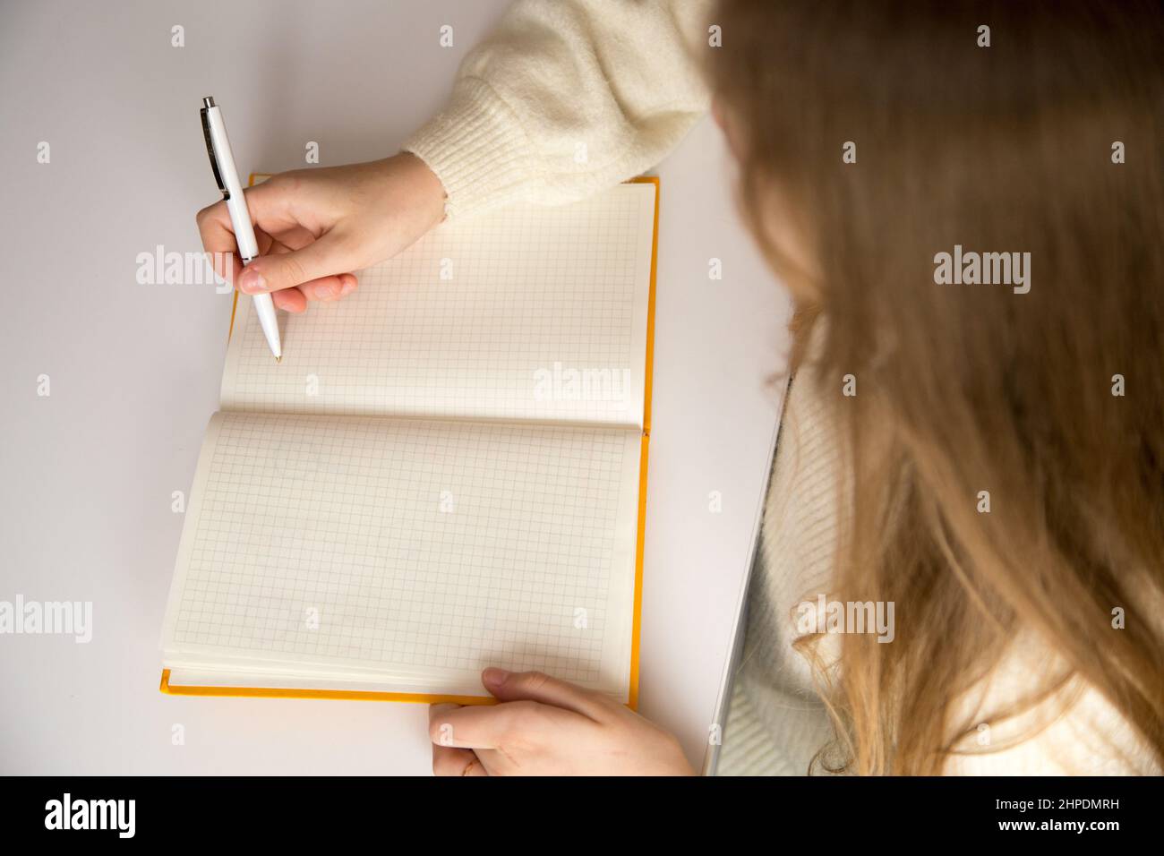 Distance learning, girl going to write or draw something on a blank ...