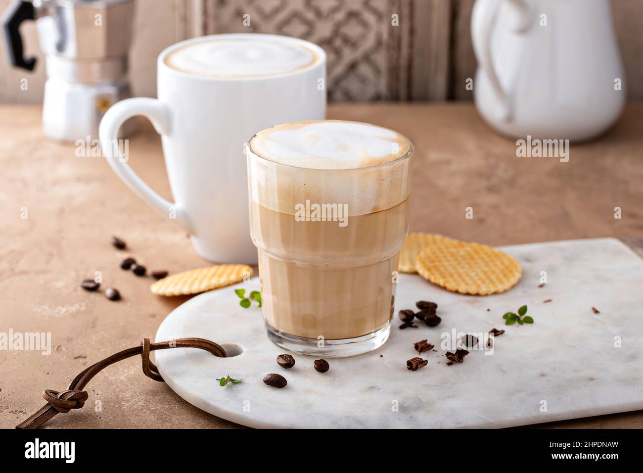 Hot coffee latte and cappuchino in a glass and mug Stock Photo - Alamy
