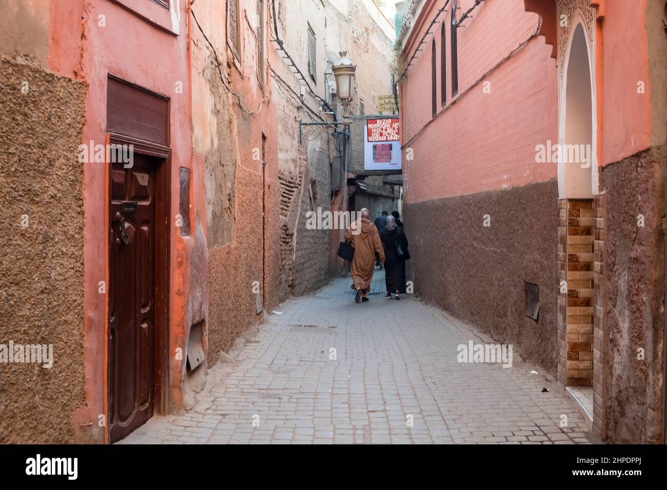 Marrakech locals navigate the narrow alleyways of the Medina Stock ...