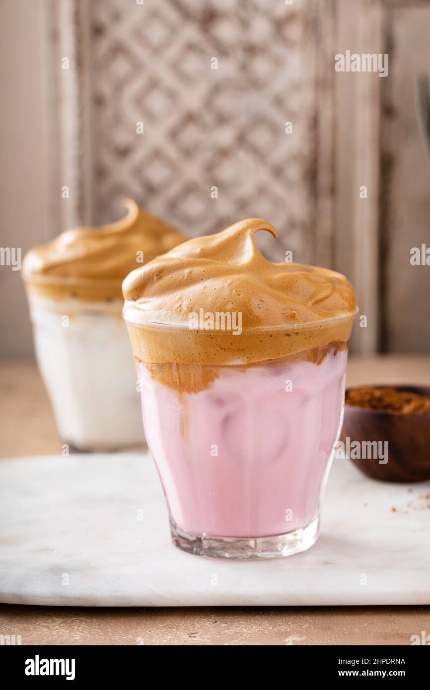 Dalgona whipped coffee with iced strawberry milk in a glass, trendy ...