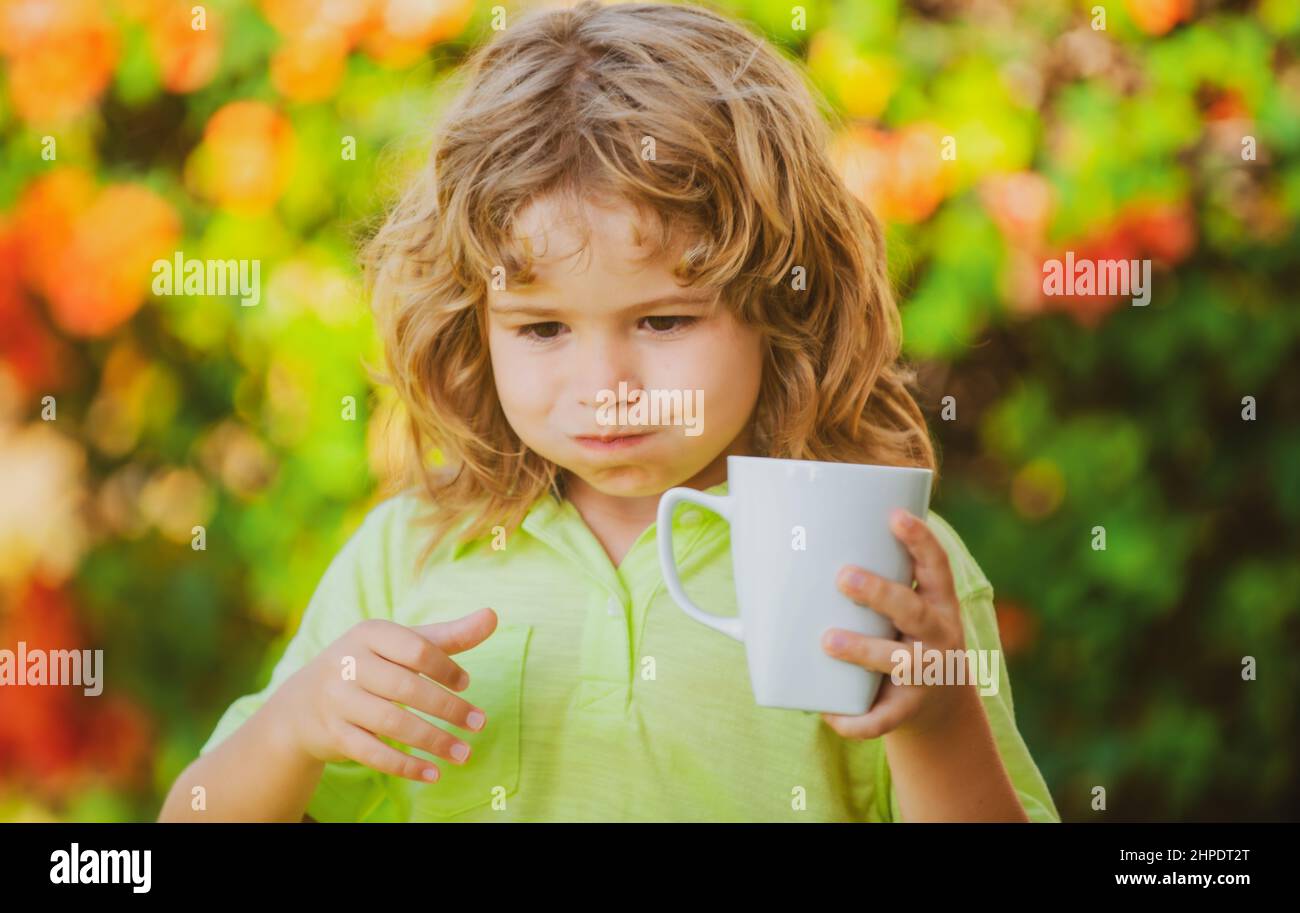 Child drinking tea or water in backyard garden. Healing kids and ...