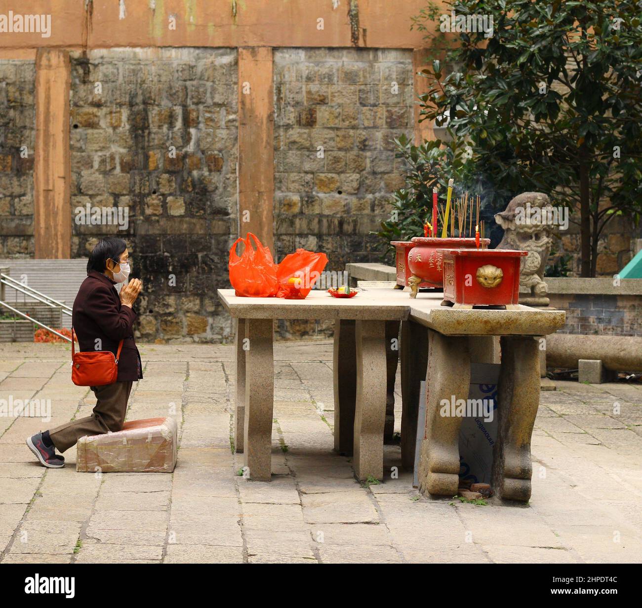 Praying in front of the old incense pot Stock Photo - Alamy