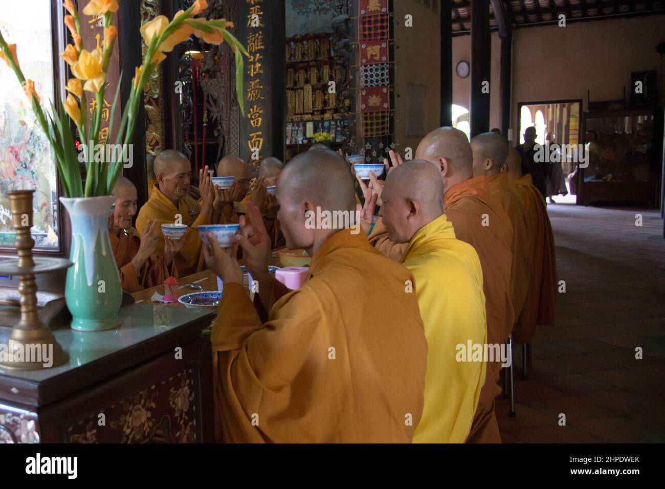 Group of Monks in the traditional clothing with bowls in hands at Thien ...