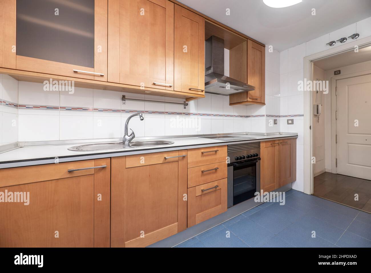 full kitchen with white wood countertops with cherry cabinets and ...