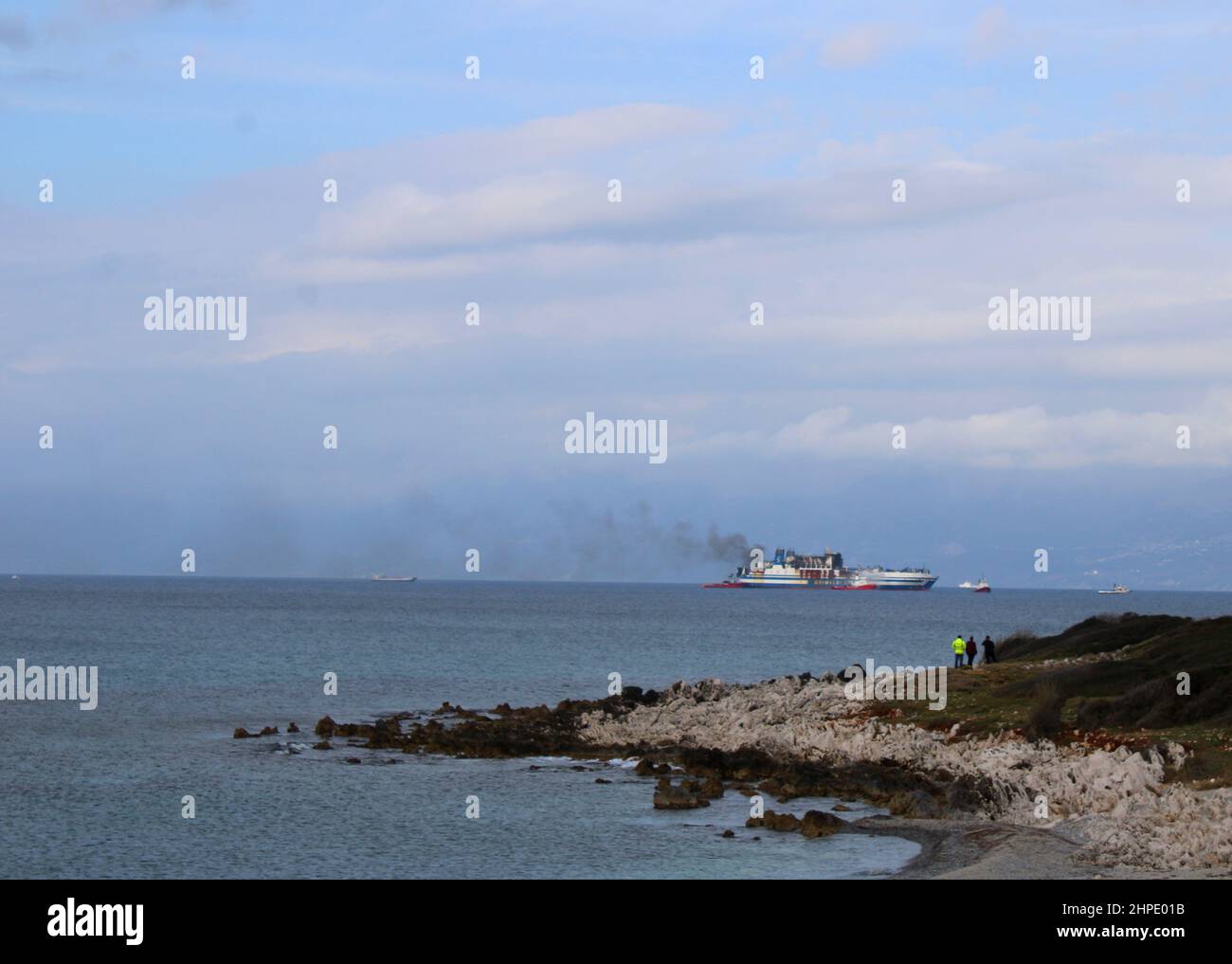 Sightseers watching the burning ferry Euroferry Olympia off the coast ...