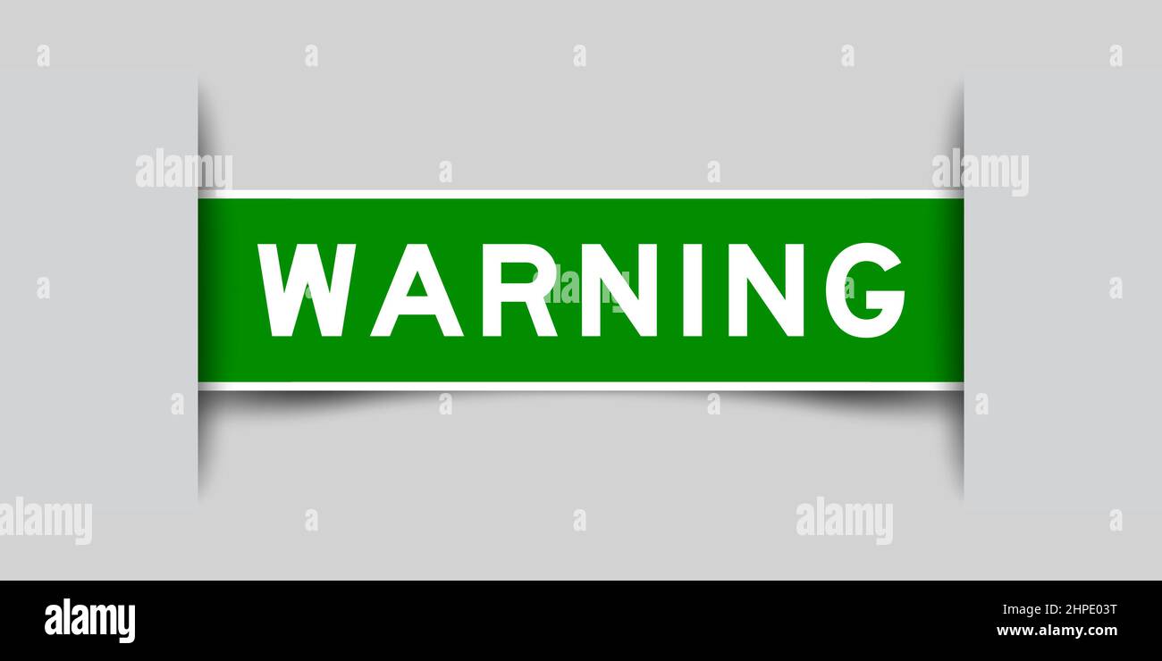 Inserted green color label sticker with word warning on gray background ...