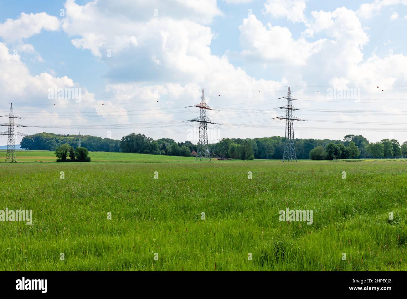 Shot of a field with electrical towers Stock Photo - Alamy