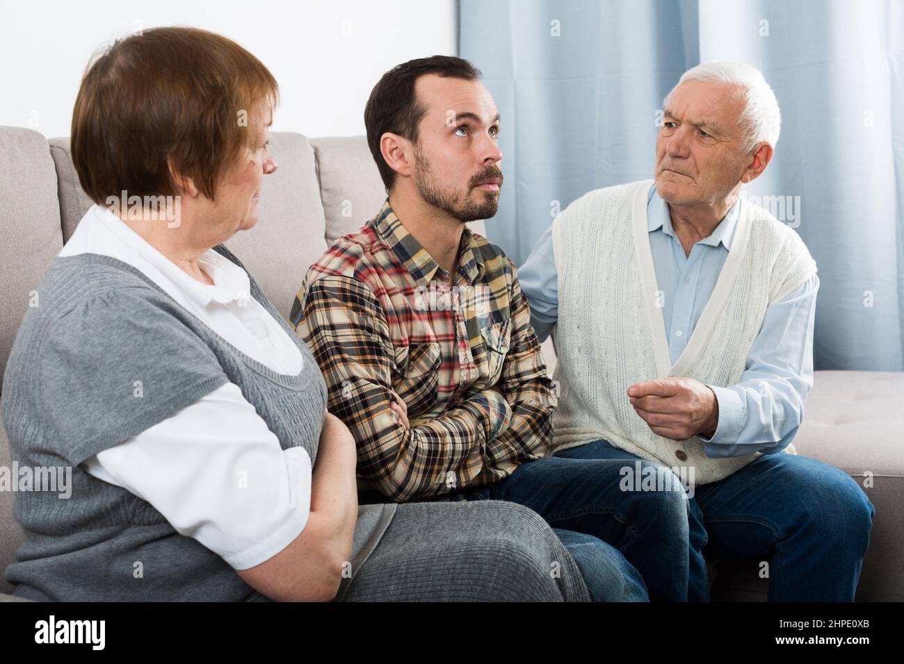 Parents arguing with son Stock Photo - Alamy