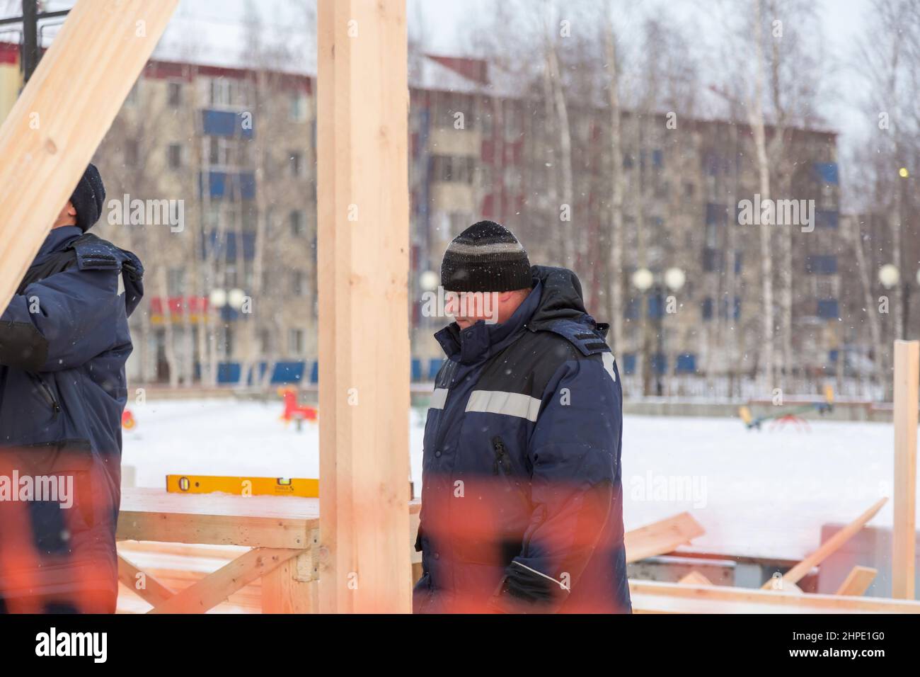 Workers level the wooden beam of the frame of a wooden slide Stock ...