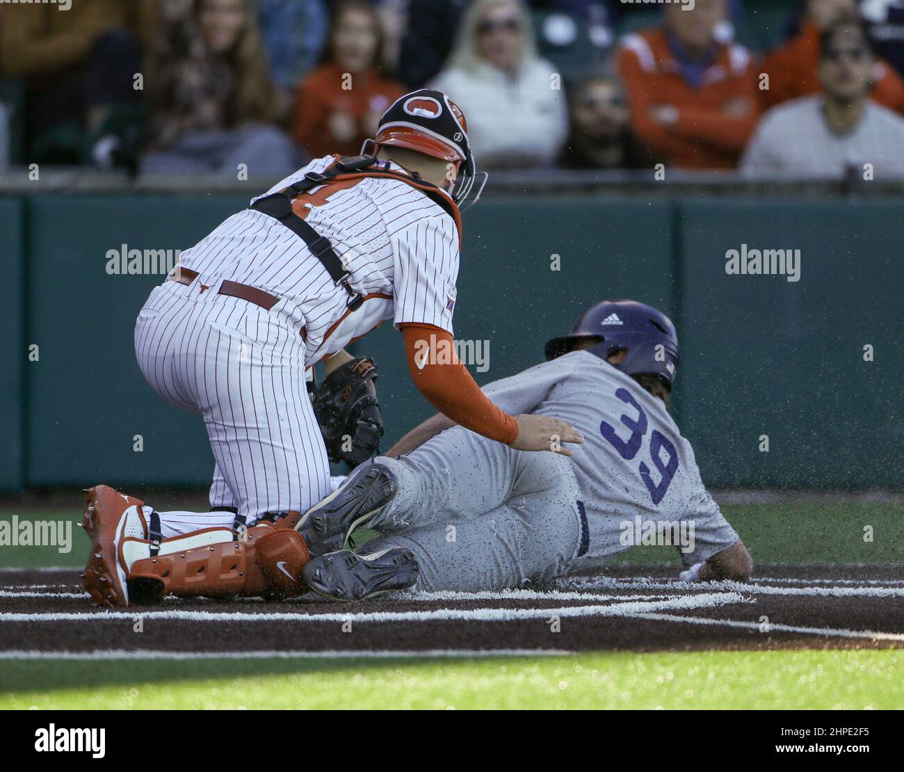 Texas, US, February 19, 2022: Texas catcher SILAS ARDOIN (4) tags out ...