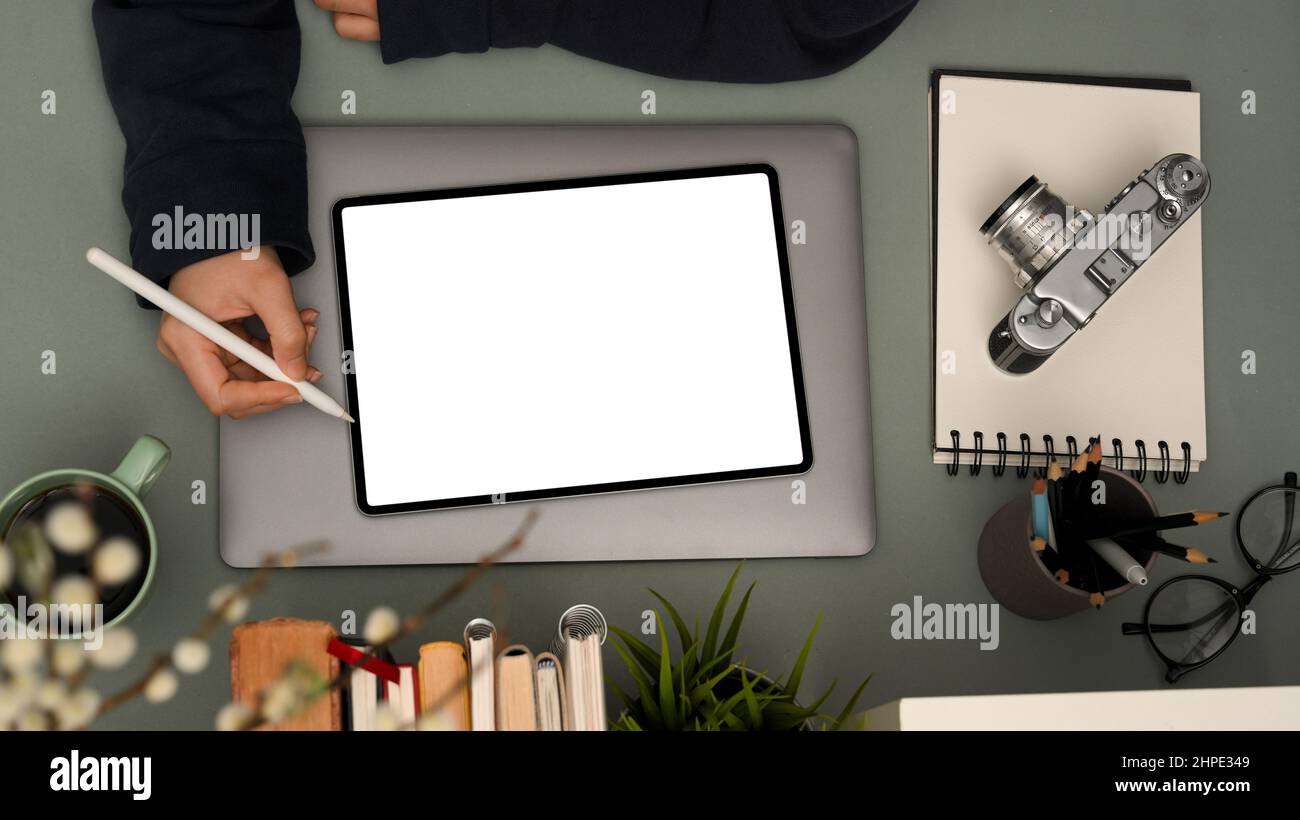 Female hands using stylus pen drawing on tablet screen over her modern ...