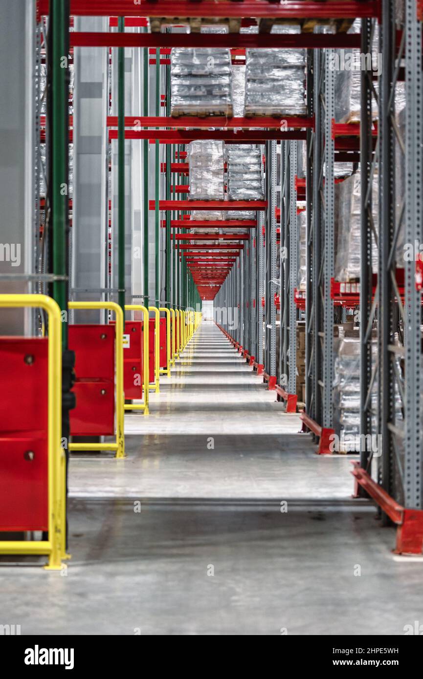 Lifting equipment with cargo near high shelving in storage Stock Photo ...