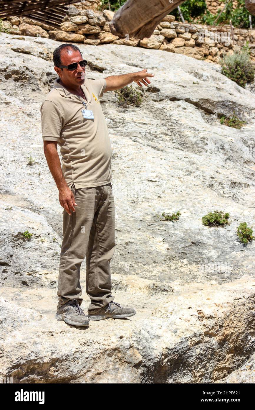 A guide directs visitors at the Nazareth Village Open Air Museum in ...