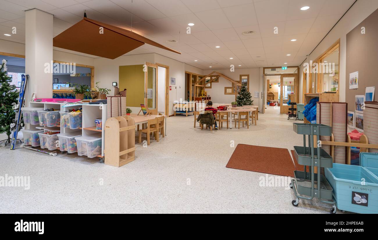Spacious inner square in a primary school with a young student sitting ...