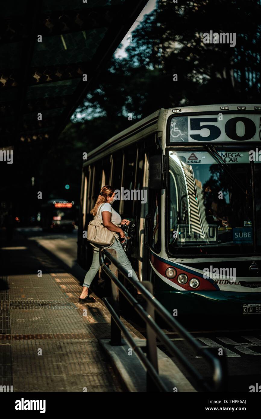 Woman getting on bus in city hi-res stock photography and images - Alamy