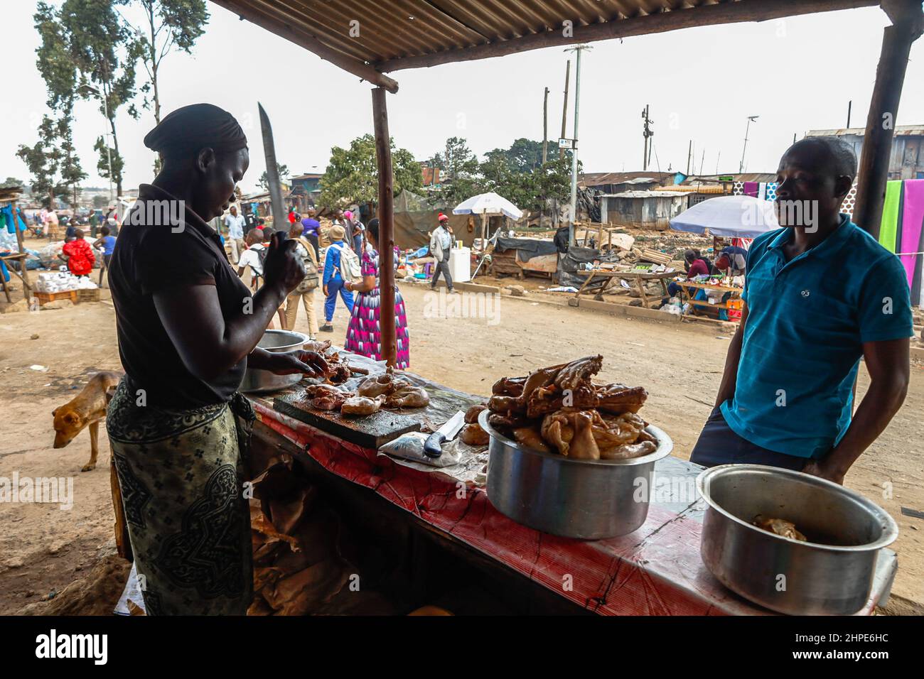 A woman sells fried chicken by the streets in Kibera Slums. (Photo by ...