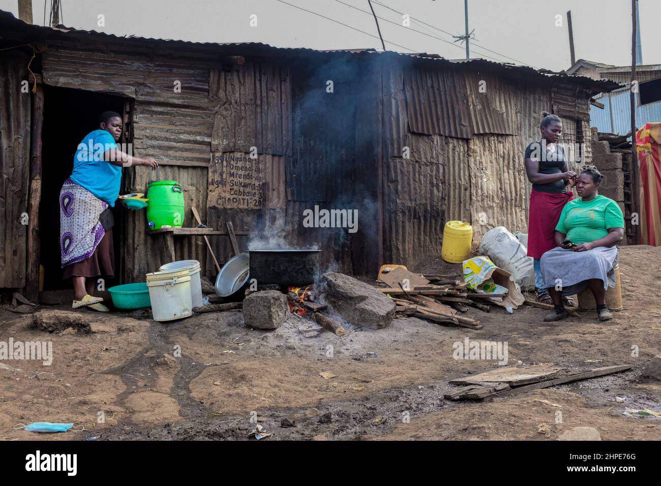 Nairobi, Kenya. 18th Feb, 2021. Women are seated by a local street ...