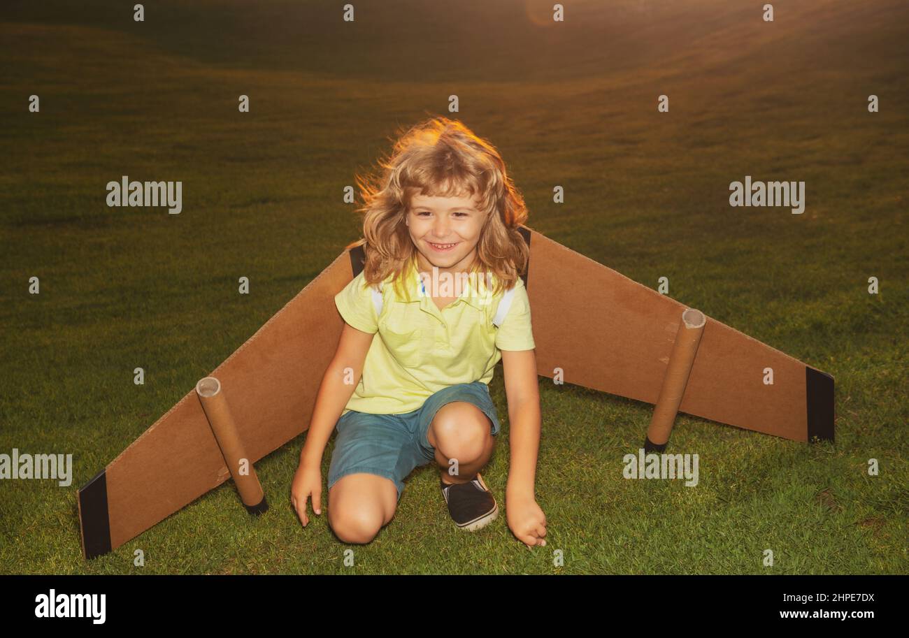 Child flying in plane made craft of cardboard wings. Dream, imagination ...