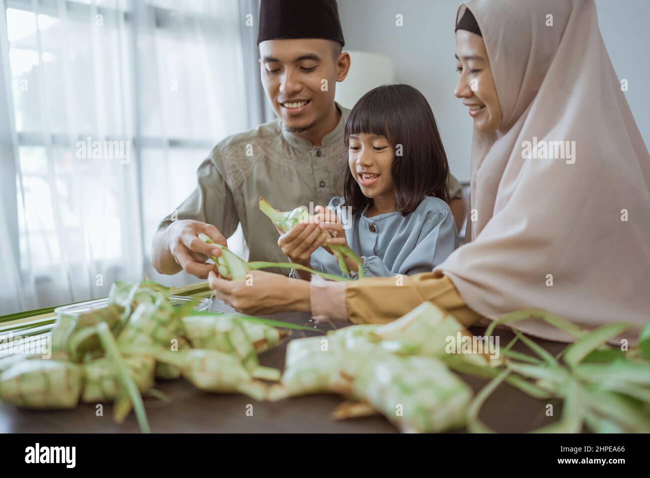 muslim asian family making ketupat for eid mubarak together Stock Photo ...
