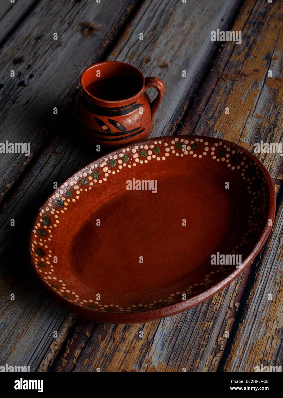 Mexican plates made of mud or clay on a rustic wooden table Stock Photo ...