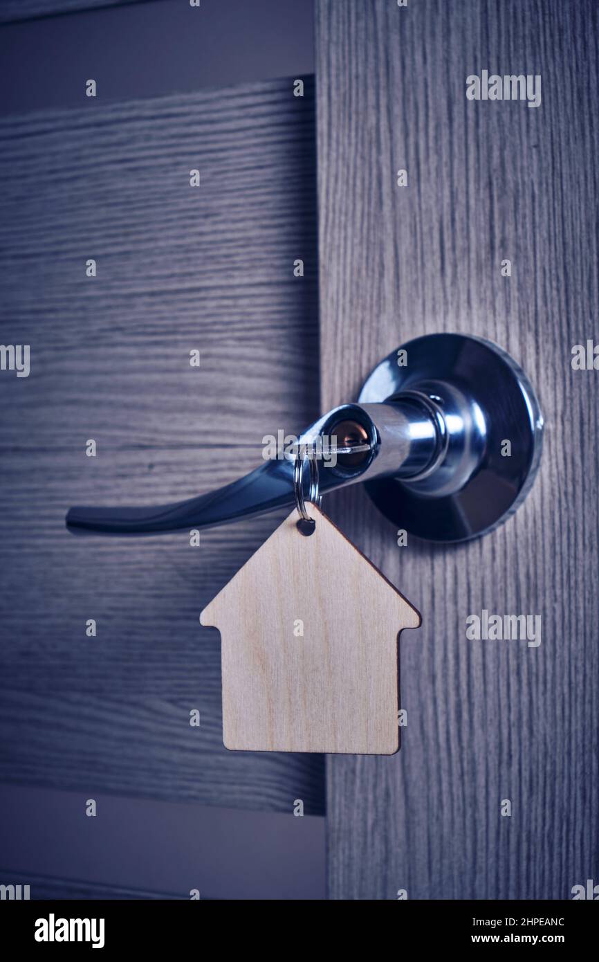 Key with keychain in form house in door lock Stock Photo - Alamy