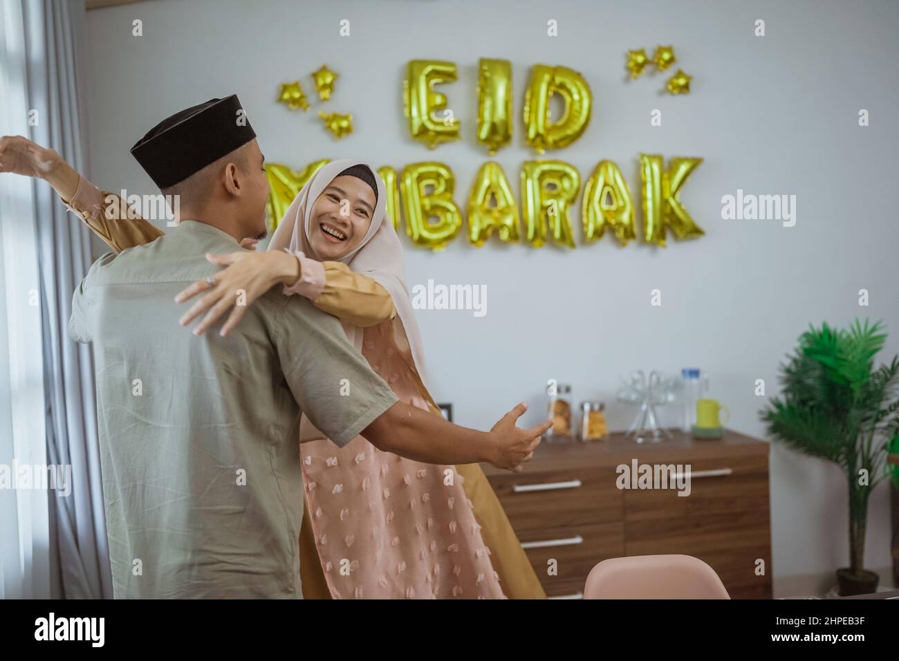 muslim couple embracing each other during eid mubarak Stock Photo - Alamy