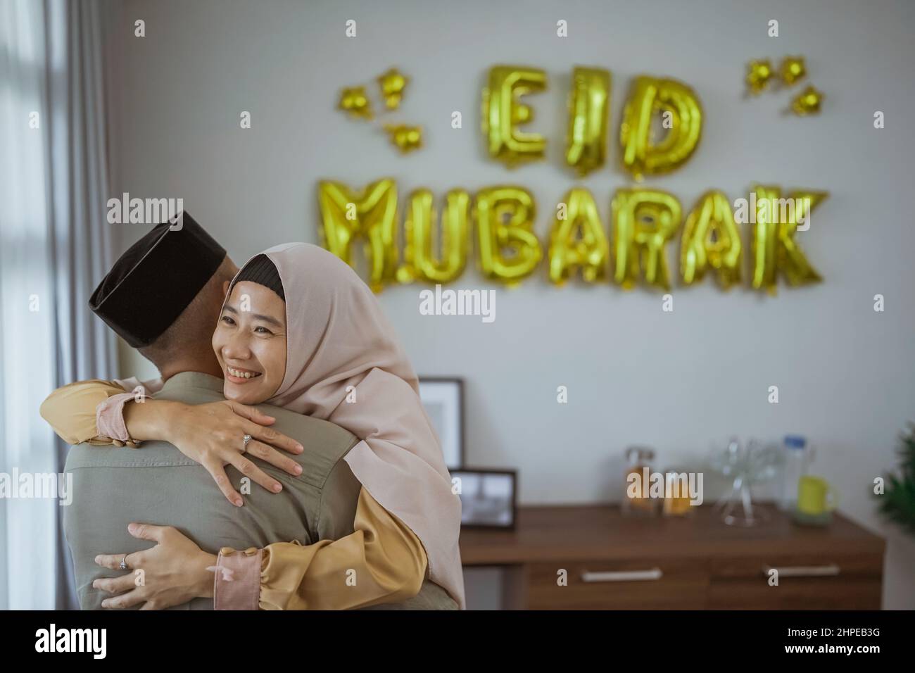 muslim couple embracing each other during eid mubarak Stock Photo - Alamy