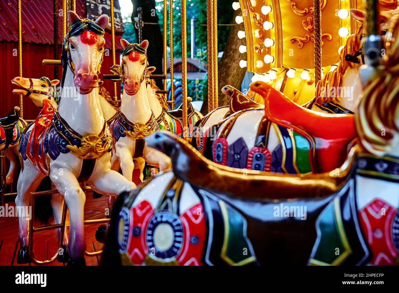 Carousel with colorful horses at amusement park, Merry go round with ...