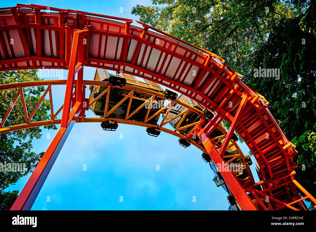 Part of looping roller coaster at summer day, Riding a rollercoaster at ...