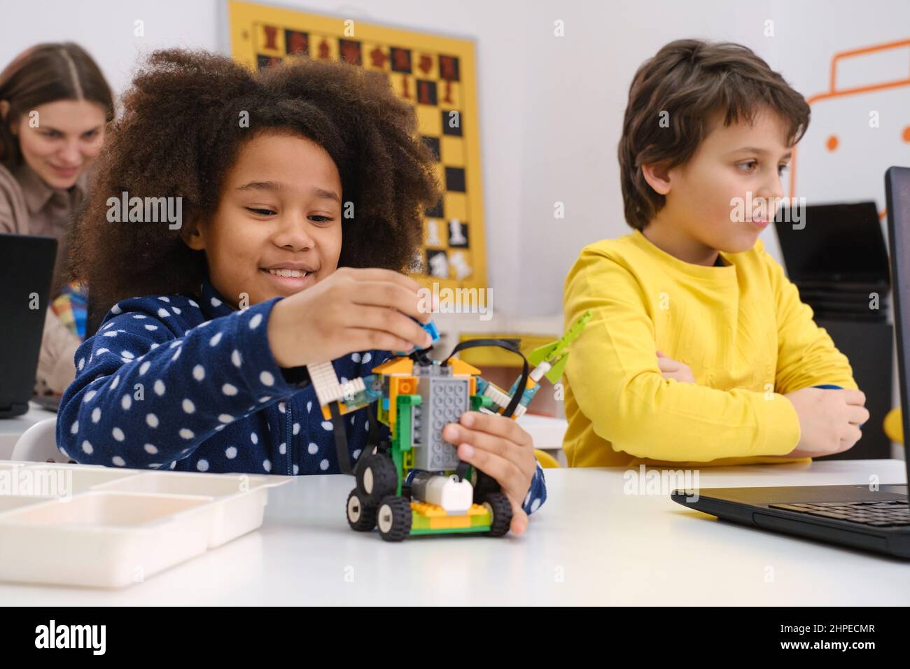 Kids learning coding, science and technology at school class. African ...