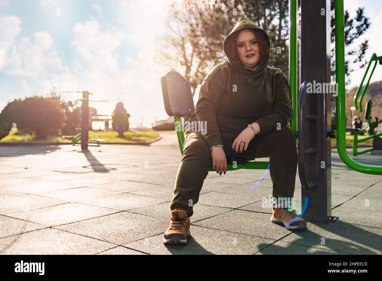 Self-confident overweight woman in a tracksuit posing at exercise ...