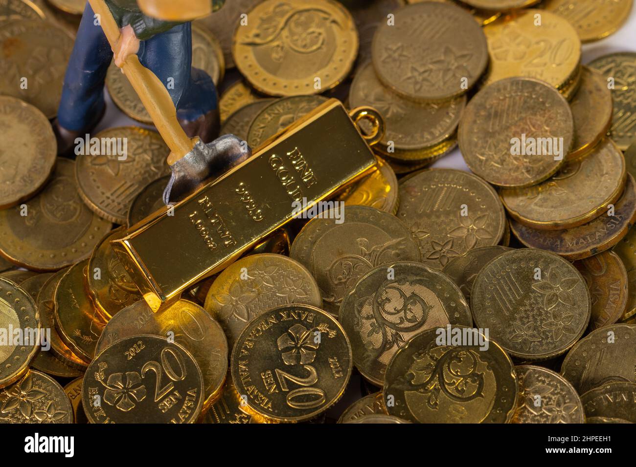 Industrial Engineering worker digging with gold bar and coin as ...