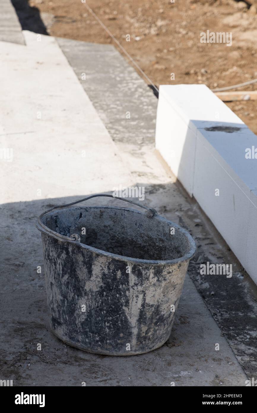 Vertical shot of a bucket on a construction site Stock Photo - Alamy