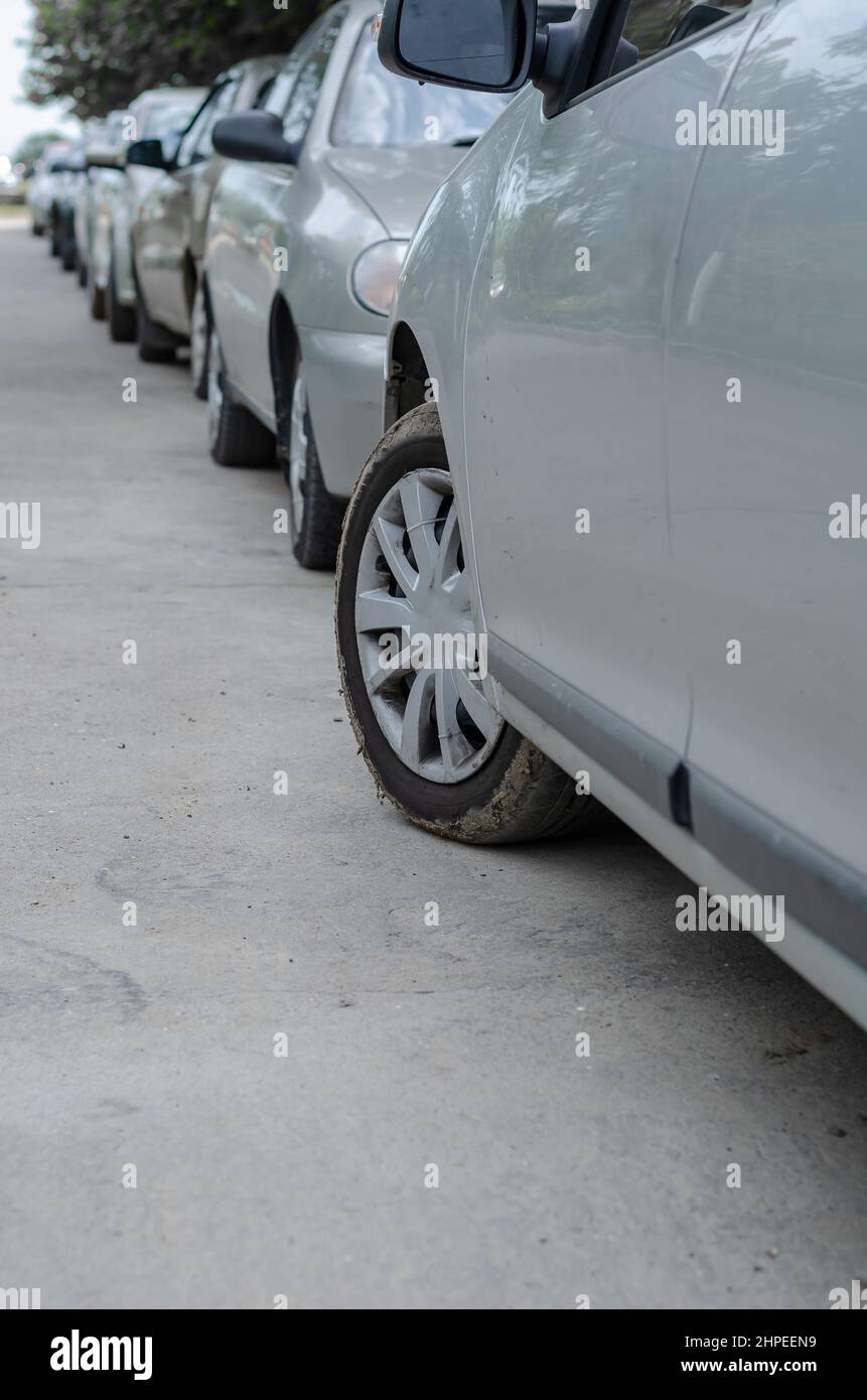 Rows of cars parked on the side of the road in a residential area. Lots ...
