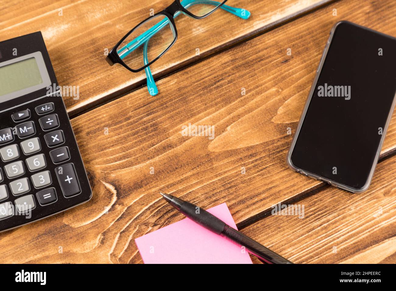 Desk with a calculator, pencil, sticky notes, and other objects Stock ...