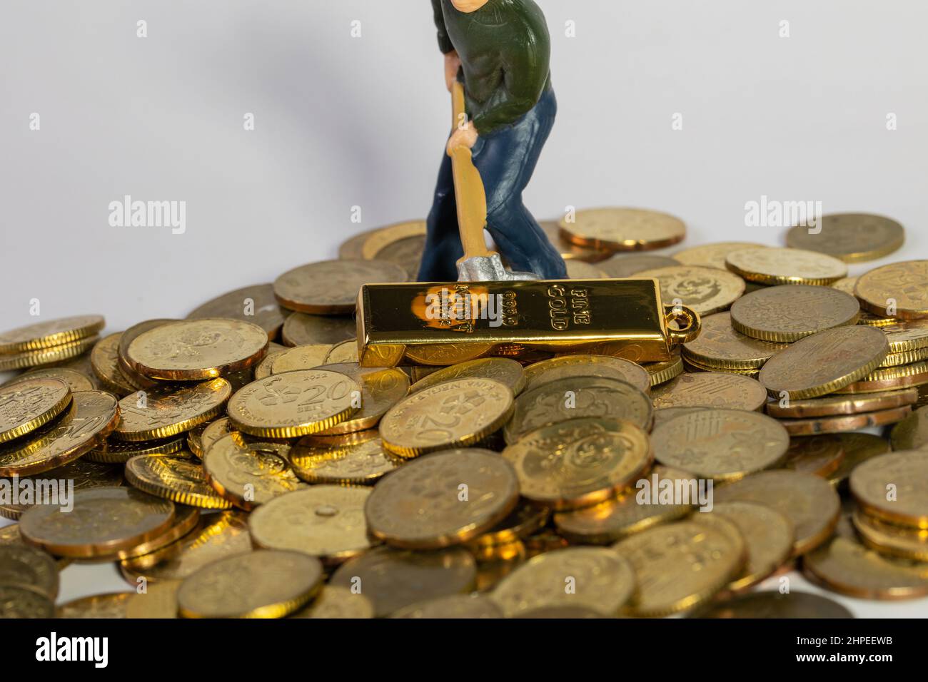 Industrial Engineering worker digging with gold bar and coin as ...